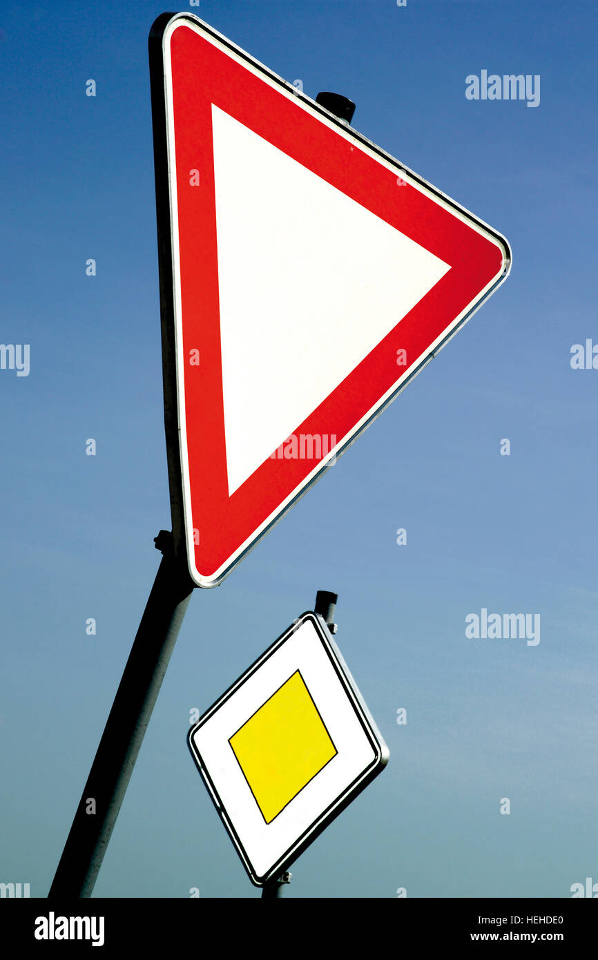 Traffic signs, yield and yield to the right-of-way Stock Photo - Alamy