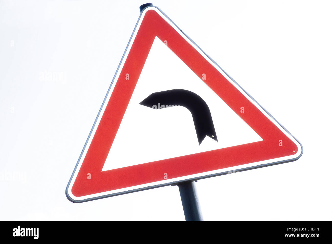 Traffic sign, curve to the left Stock Photo - Alamy