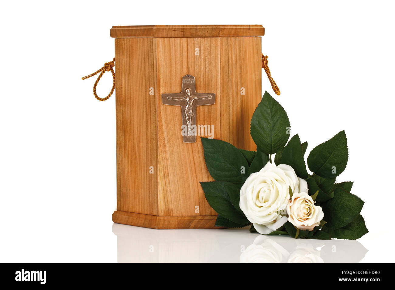 Urn decorated with a crucifix and white roses Stock Photo - Alamy