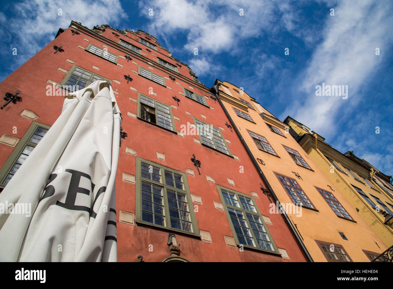 Looking up at red and yellow houses in the central square of Gamla Stan ...