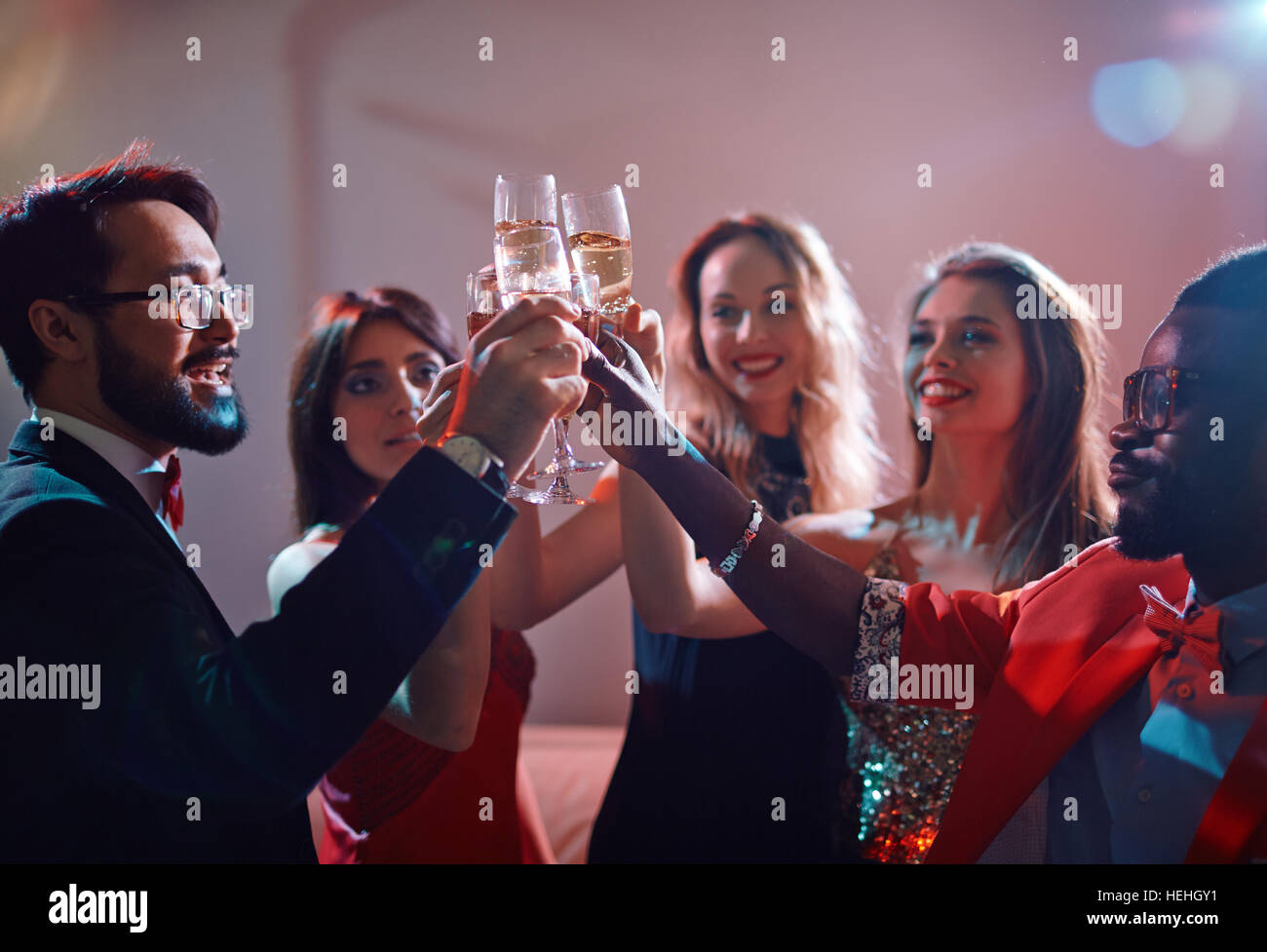 Happy friends with flutes cheering up at party Stock Photo - Alamy