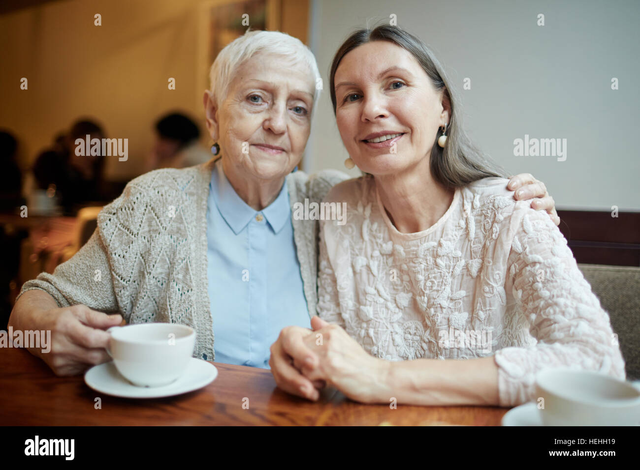 Two friendly grandmas having tea in cafe Stock Photo - Alamy
