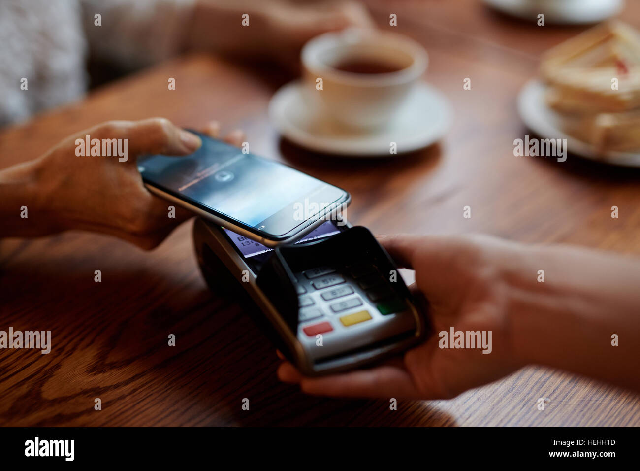 Customer making contactless payment through smartphone Stock Photo - Alamy