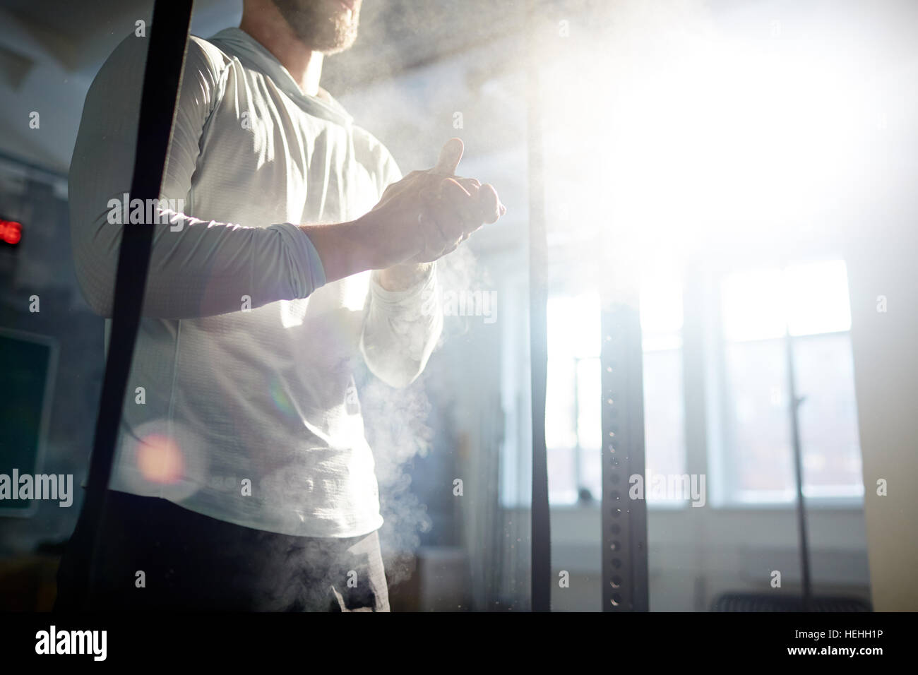 Sportsman rubbing hands with talc before weightlifting Stock Photo - Alamy