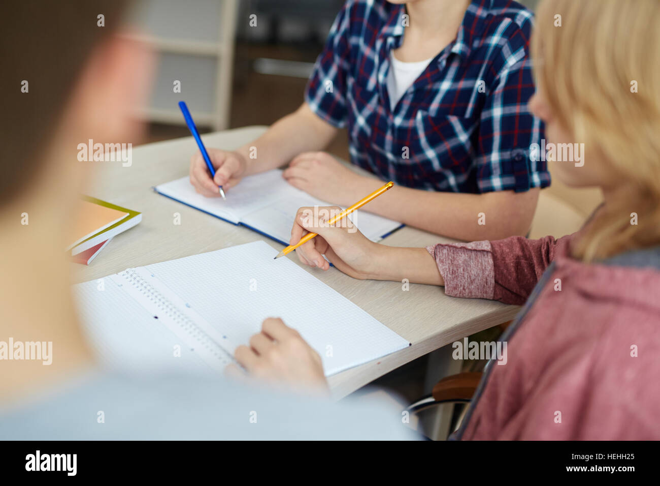 Group of students making notes or drawing sketches in copybooks Stock ...