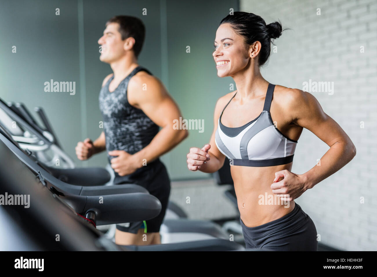 Sweating female running on treadmill Stock Photo - Alamy