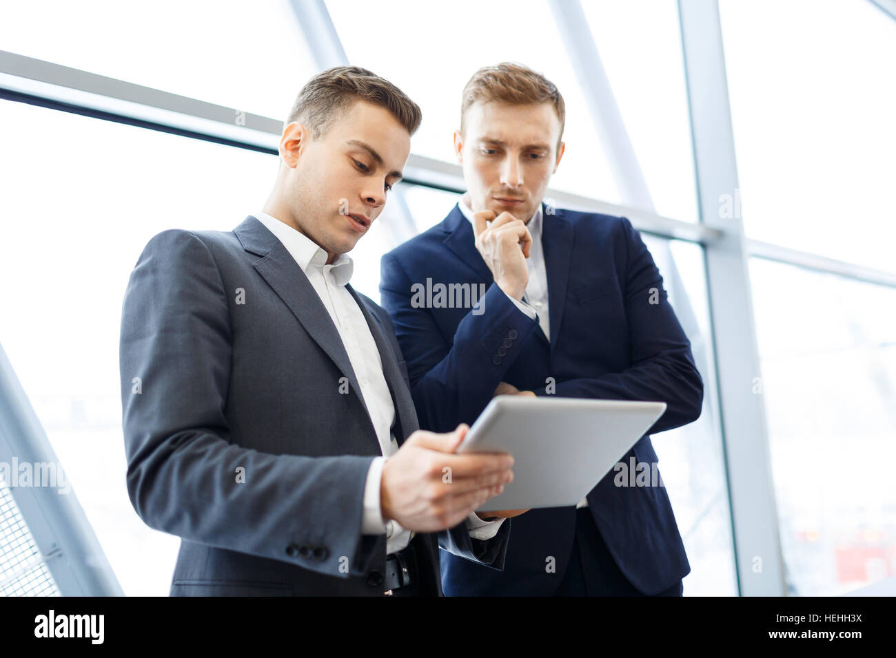 Businessmen brainstorming while networking at meeting Stock Photo - Alamy