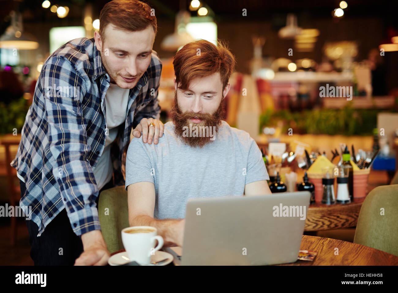 Young designers or managers networking in cafe and communicating Stock ...