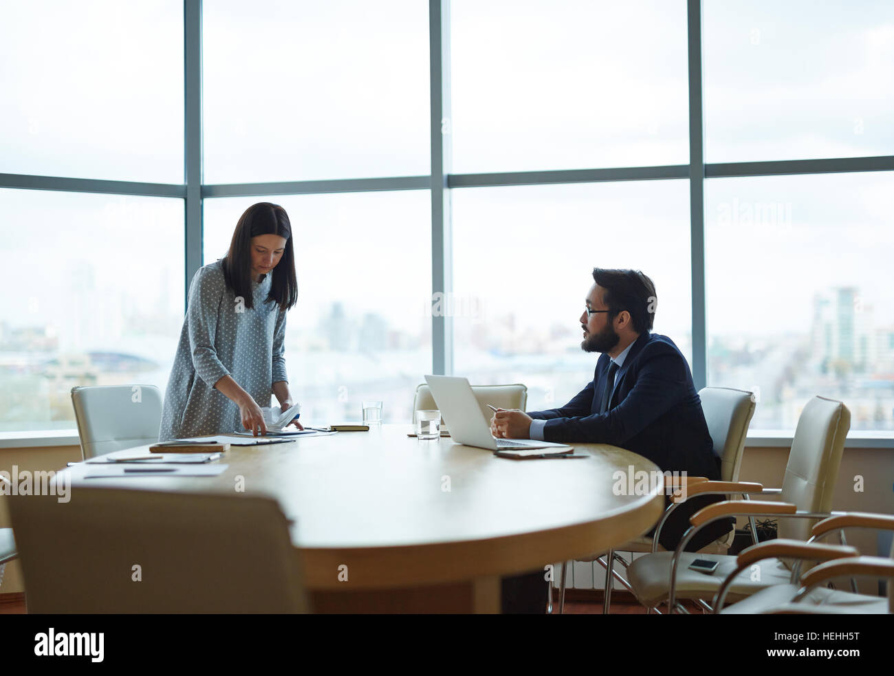 Director talking to his secretary in office before meeting with ...