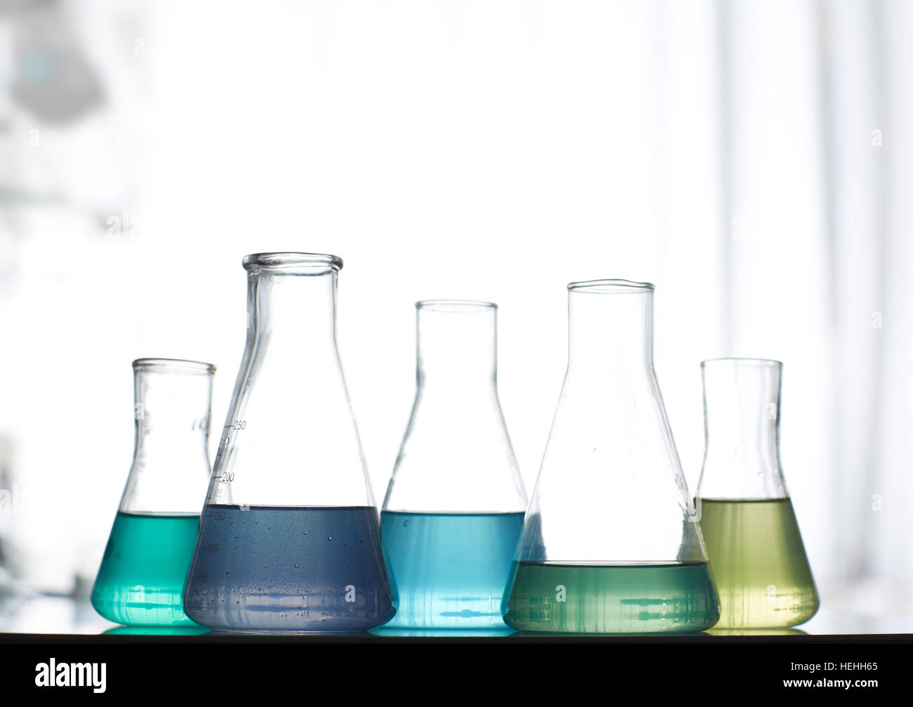 Liquid reagents in transparent beakers Stock Photo - Alamy