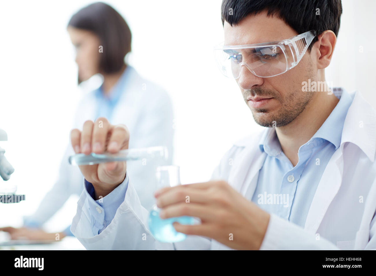 Scientist mixing chemicals hi-res stock photography and images - Alamy