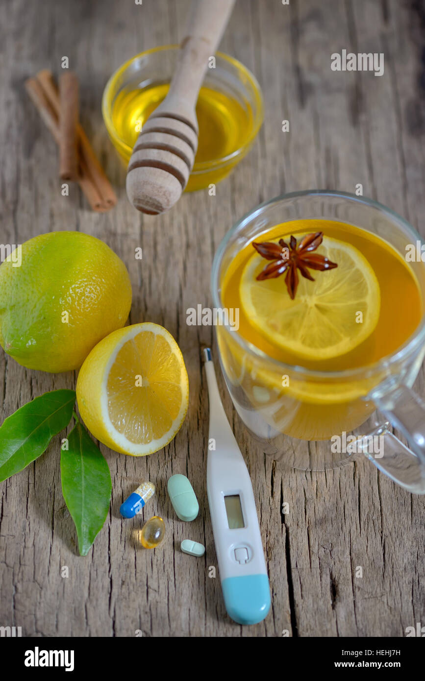 Traditional medicine and flu concept - cup of tea with lemon and honey ...