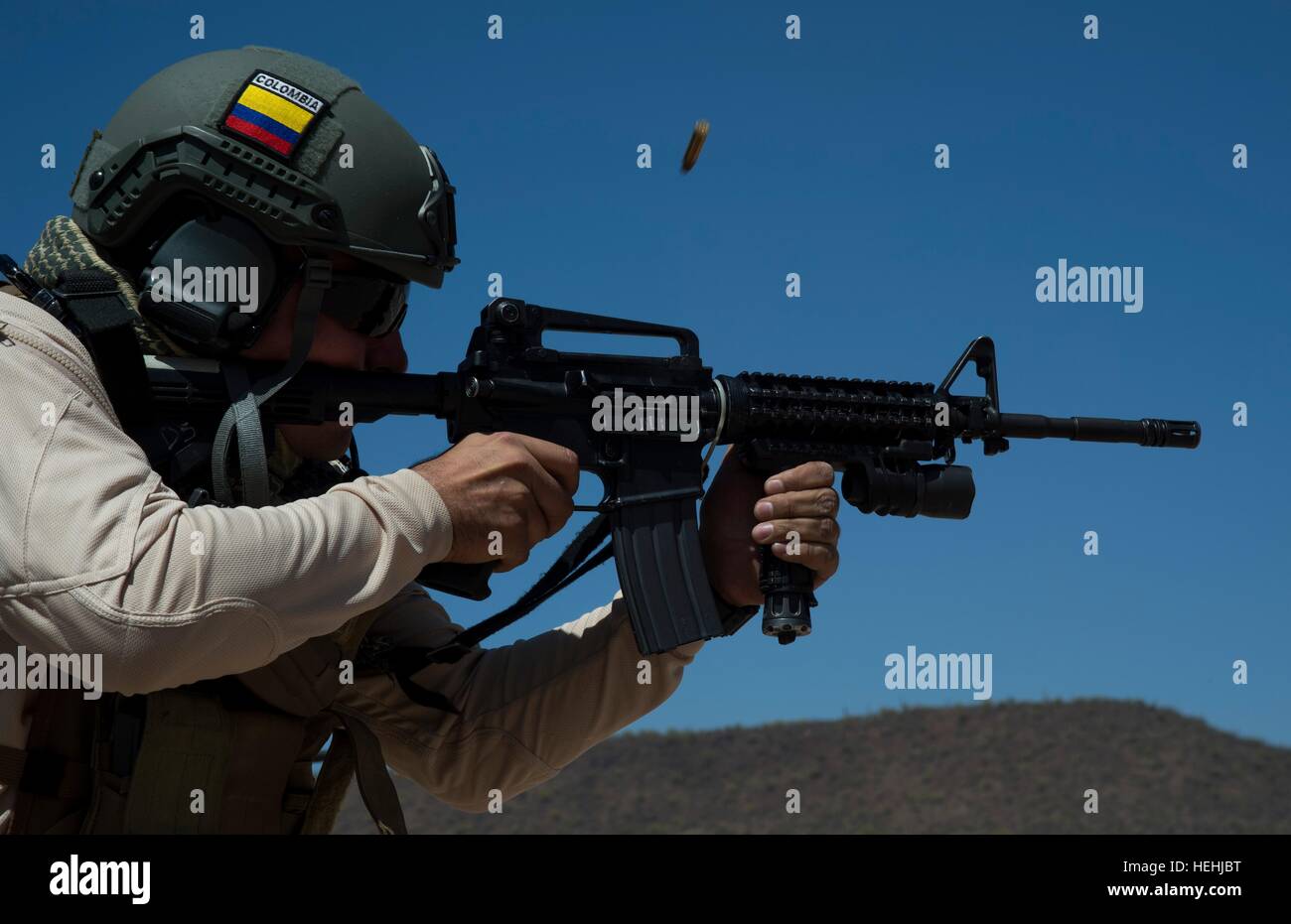 A Colombian soldier fires his weapon at a simulated target during ...