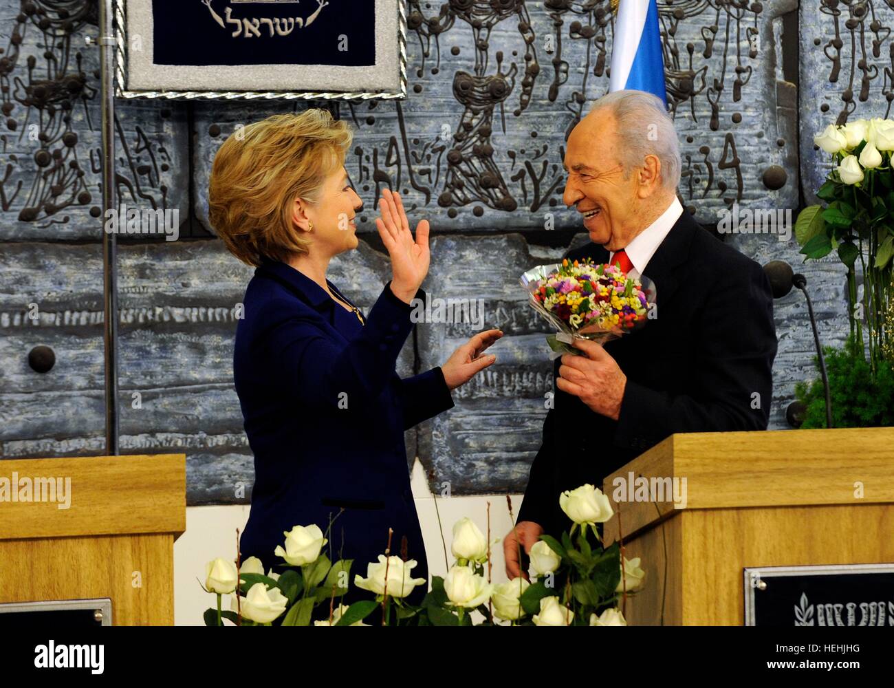 U.S. Secretary of State Hillary Clinton greets Israeli President Shimon ...