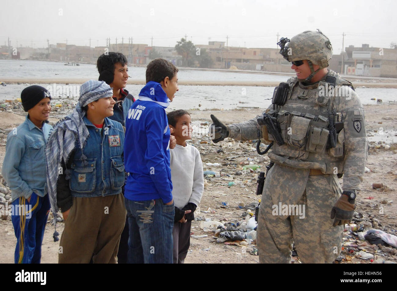 1st Lt. Tommy Ryan, of Seminole, Fla., gives a thumbs-up to children in ...
