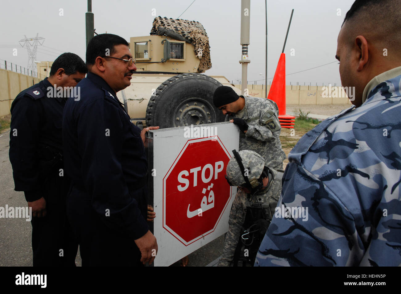 Iraqi police inspects check point signs that the U.S. Soldiers at the ...