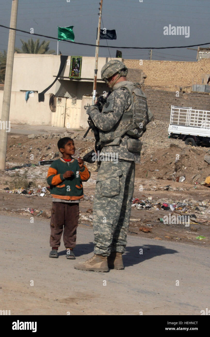 Sgt. Joshua Oden, a San Angelo, Texas, native, gives a boy a piece of ...