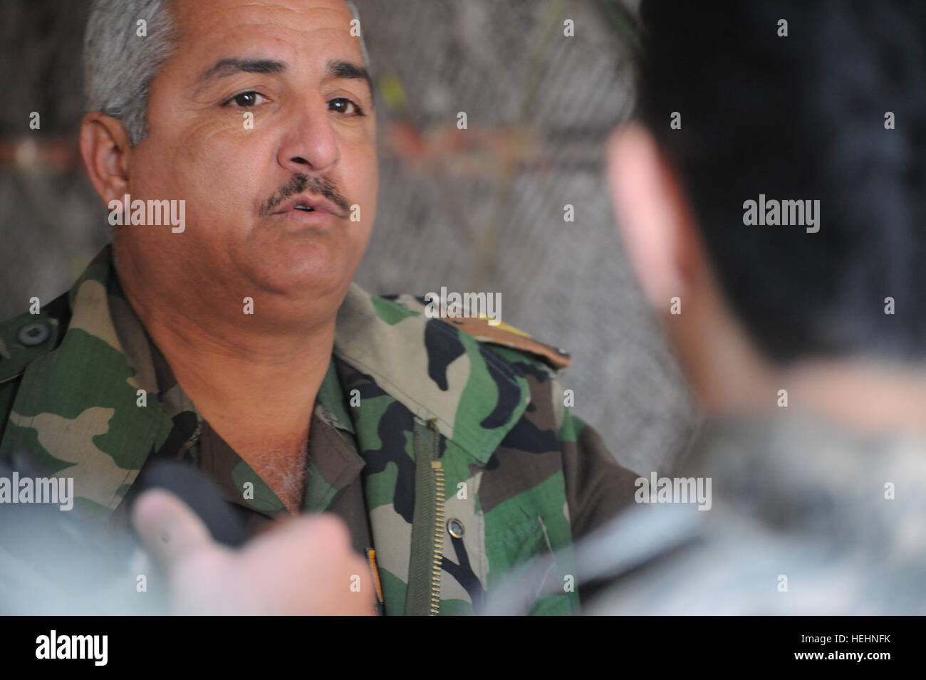 An Iraqi army officer speaks through an interpreter to U.S. Army 1st Lt ...