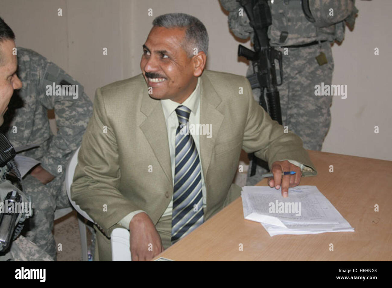 Sheik Hussein Nasser Al Wan crosses a Sons of Iraq member's name off ...