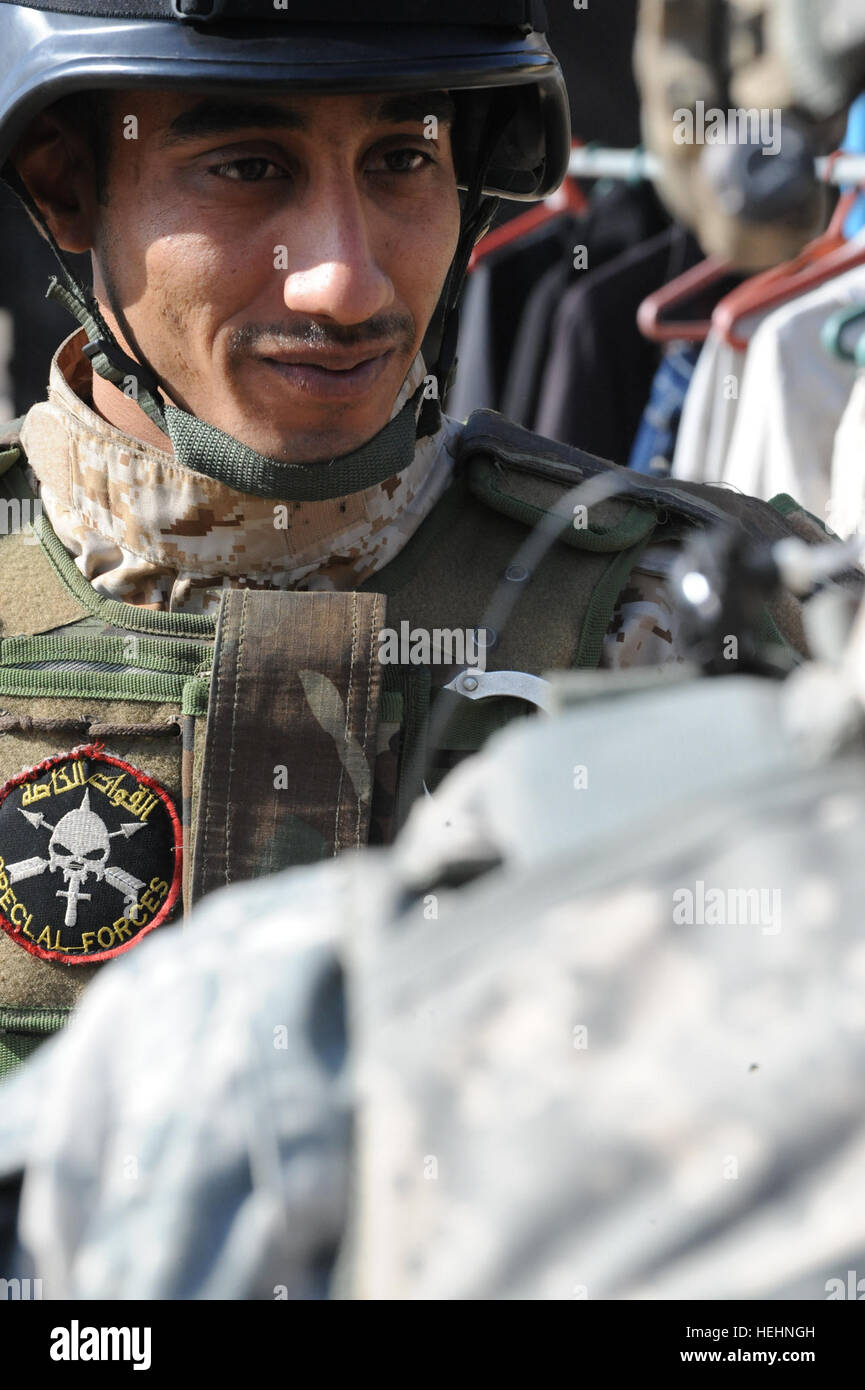 An Iraqi army non-commissioned officer talks with U.S. Soldiers of B ...