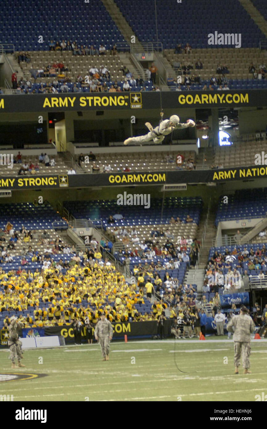 A special forces Soldier drops from the rafters of the Alamodome in San ...