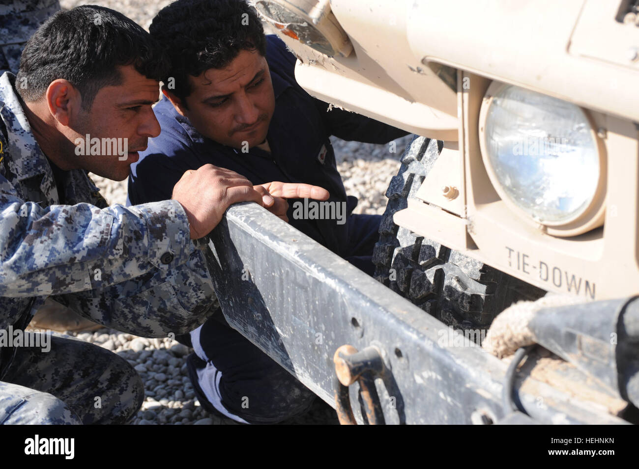 Iraqi national police mechanics examine a Humvee during Humvee ...