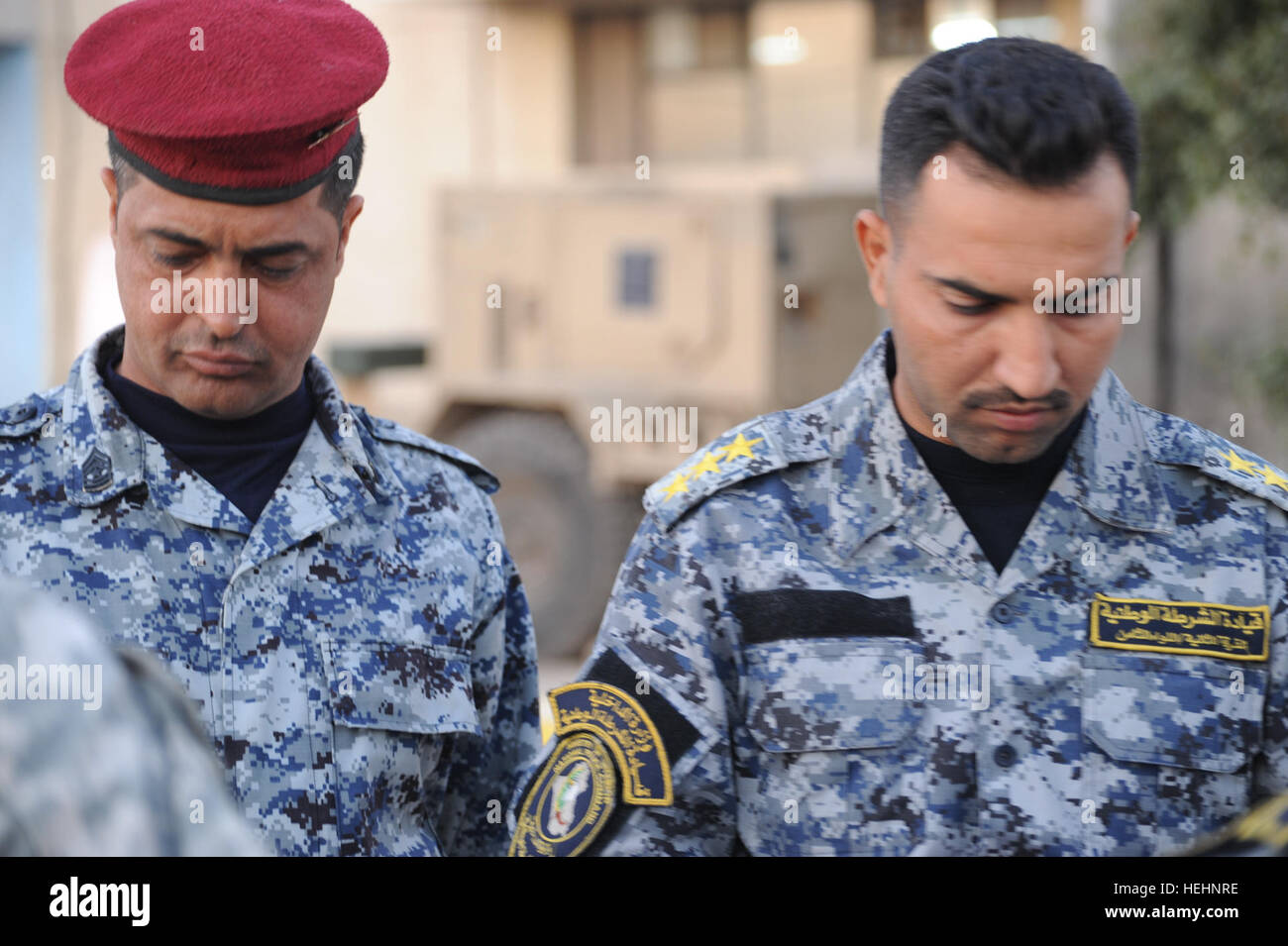 Iraqi national police Sgt. Major Ali (left) and an Iraqi national ...