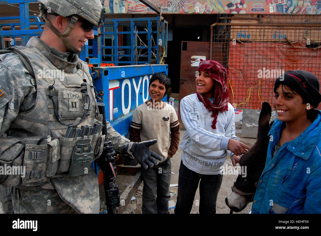 Capt. Lucas Yoho, of Long Beach, Calif., asks children in Baghdad's ...