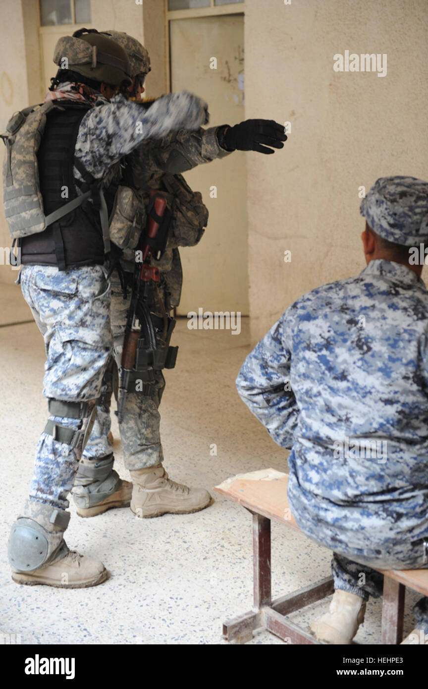 An Iraqi National Policeman of 3rd Battalion, 1st Brigade, demonstrates ...
