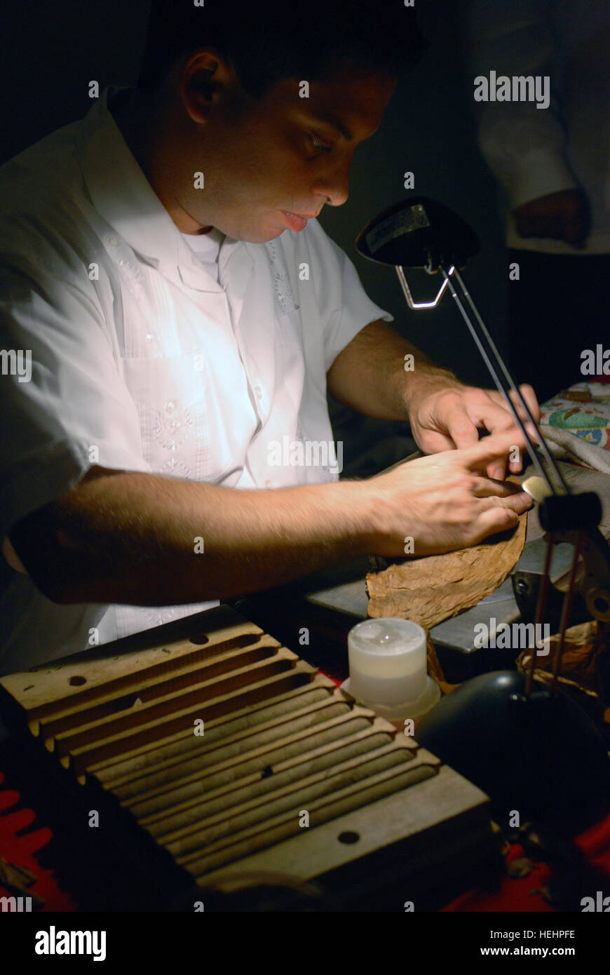 GUANTANAMO BAY, Cuba – Jorge L. Rodriguez, Jr., hand rolls a cigar for ...