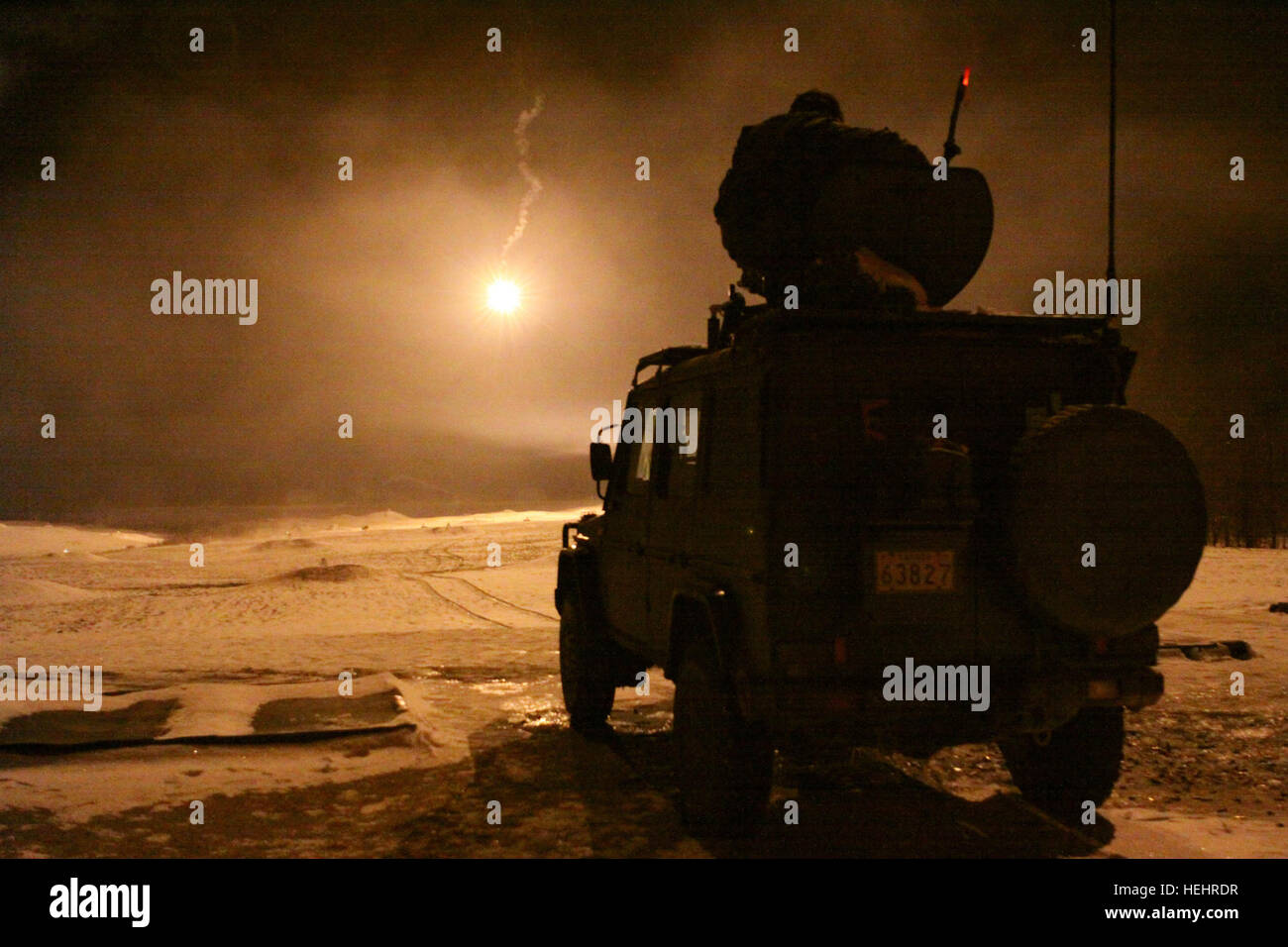 Flares illuminate the night during a live-fire training exercise with ...
