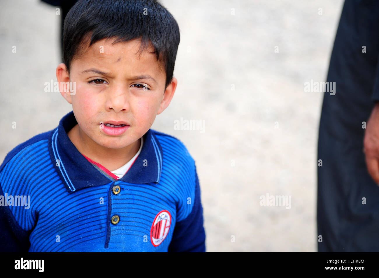 An Iraqi boy from Mamouri Gaurari, Iraq, watches U.S. Soldiers from 2nd ...