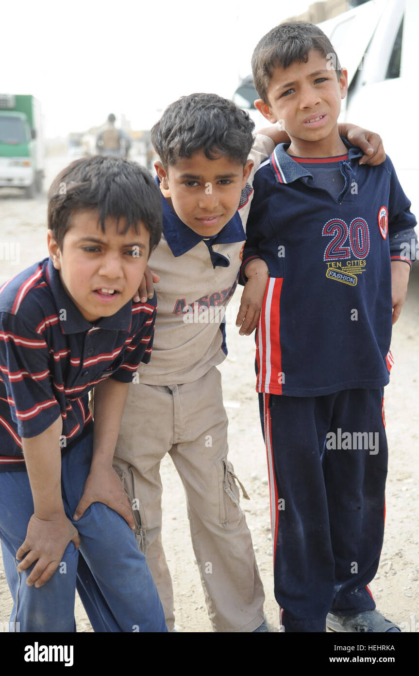 Iraqi boys pose for the camera in the street outside a school where ...