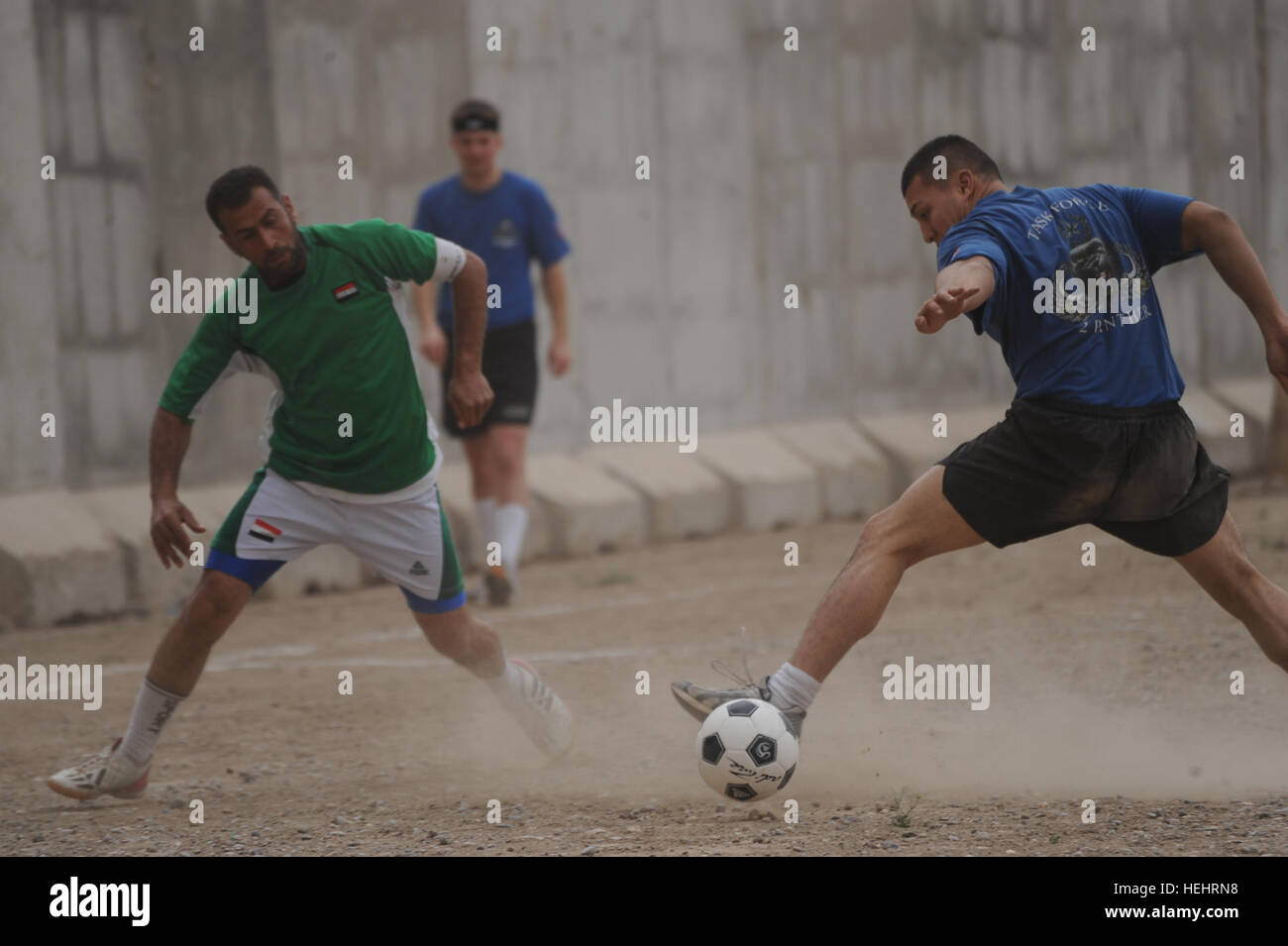 An Iraqi soccer player attempts to take control of the ball away from a ...