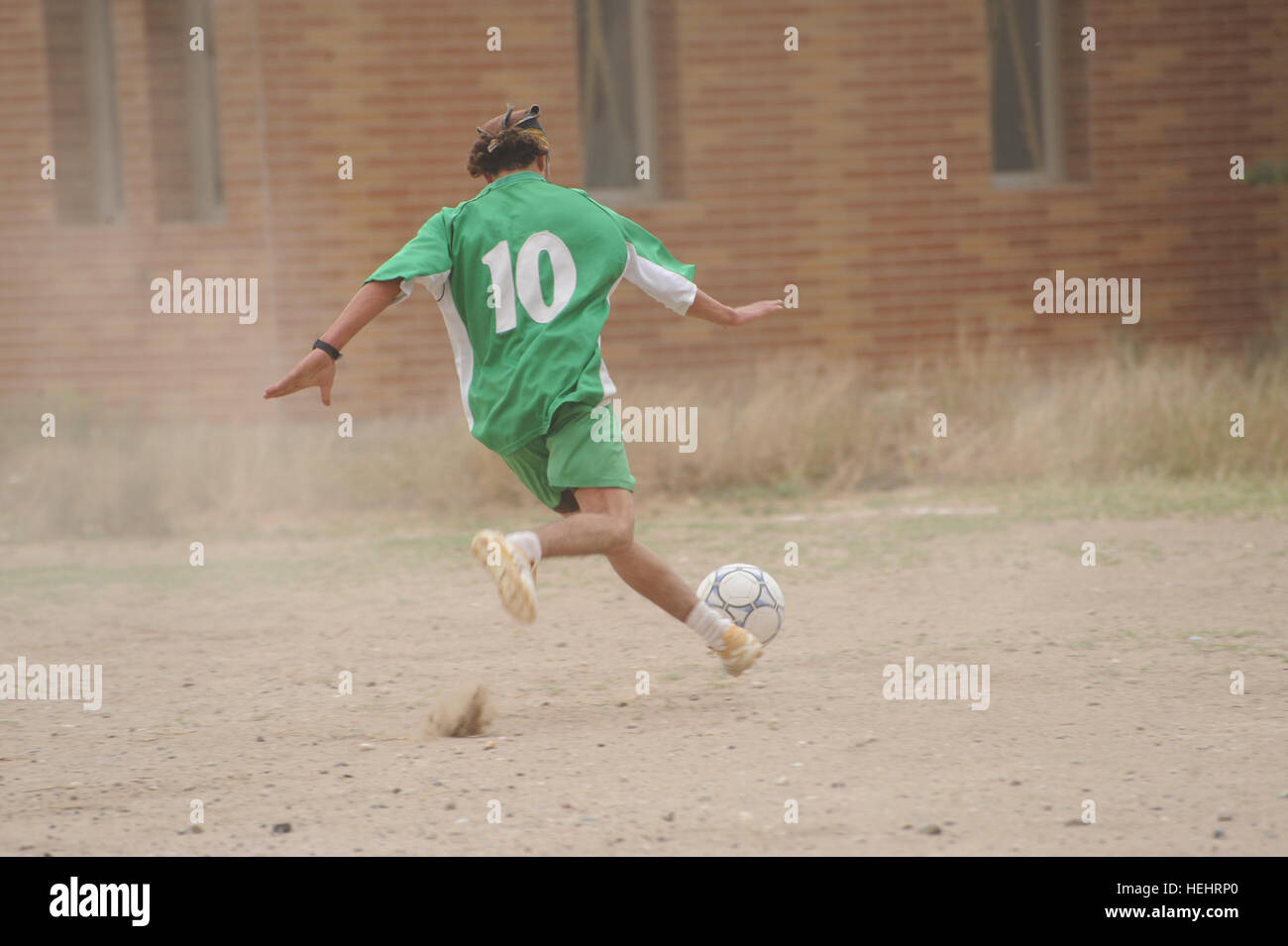 An Iraqi soccer player takes the ball down the field during a friendly ...
