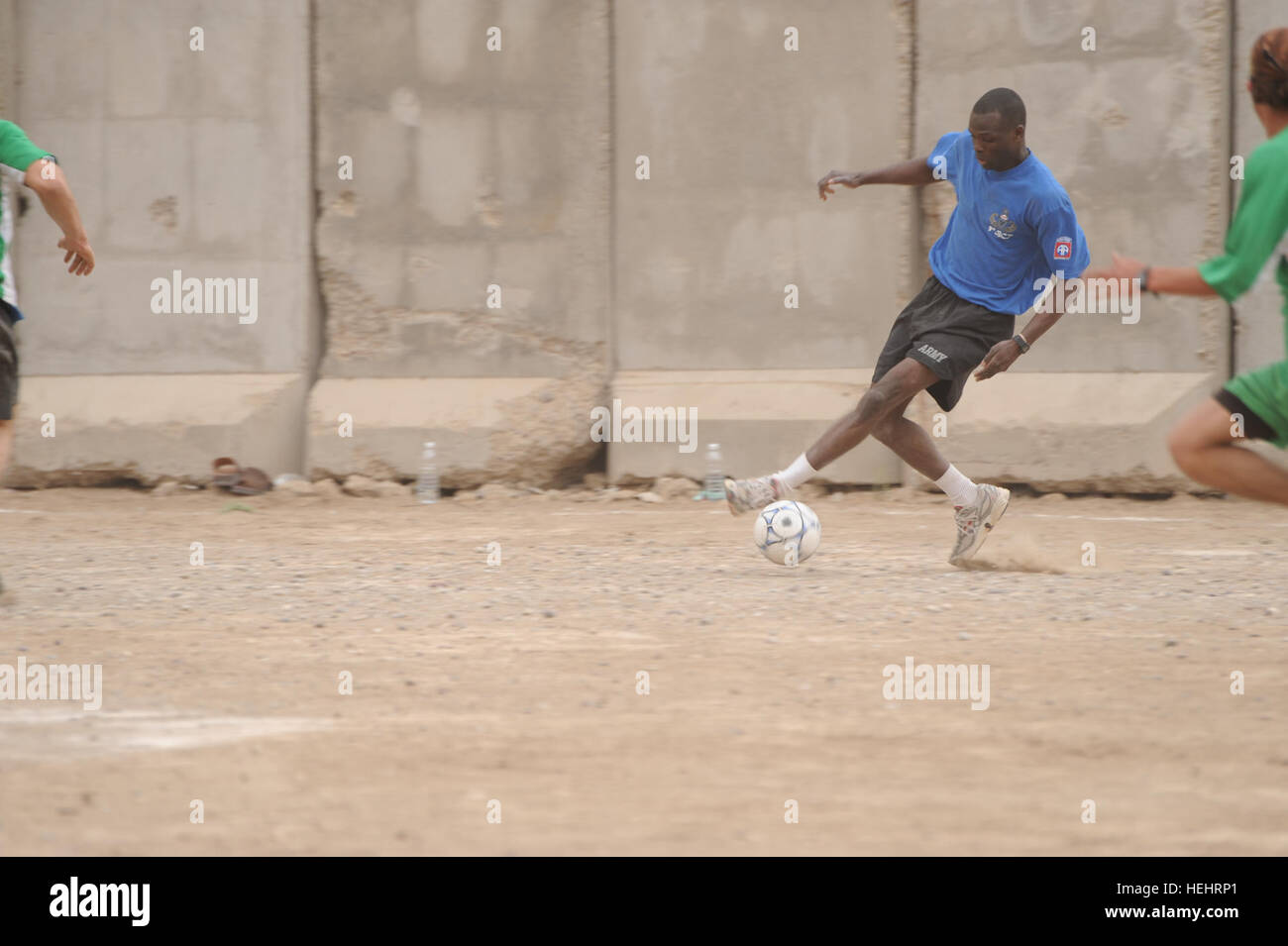 A U.S. Soldier takes the ball down the field during a friendly game of ...