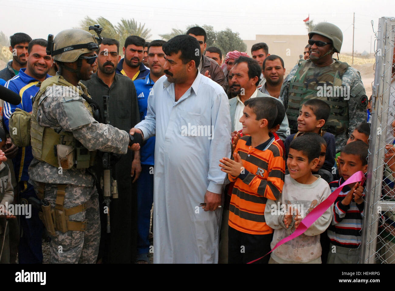 Capt. Eric Currence, commander, Civil Affairs Team 641 shakes hands ...