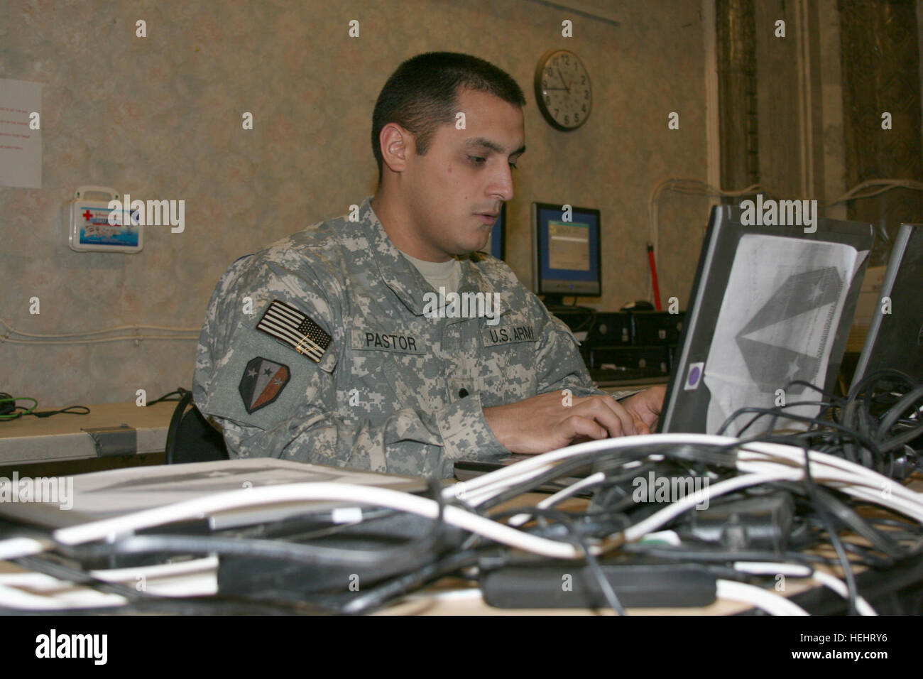 SPc. John A. Pastor conitnues on the process of migrating computerrs to ...