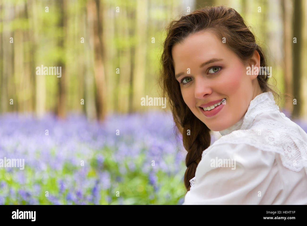 Victorian woman in white dress in a springtime bluebells forest Stock ...