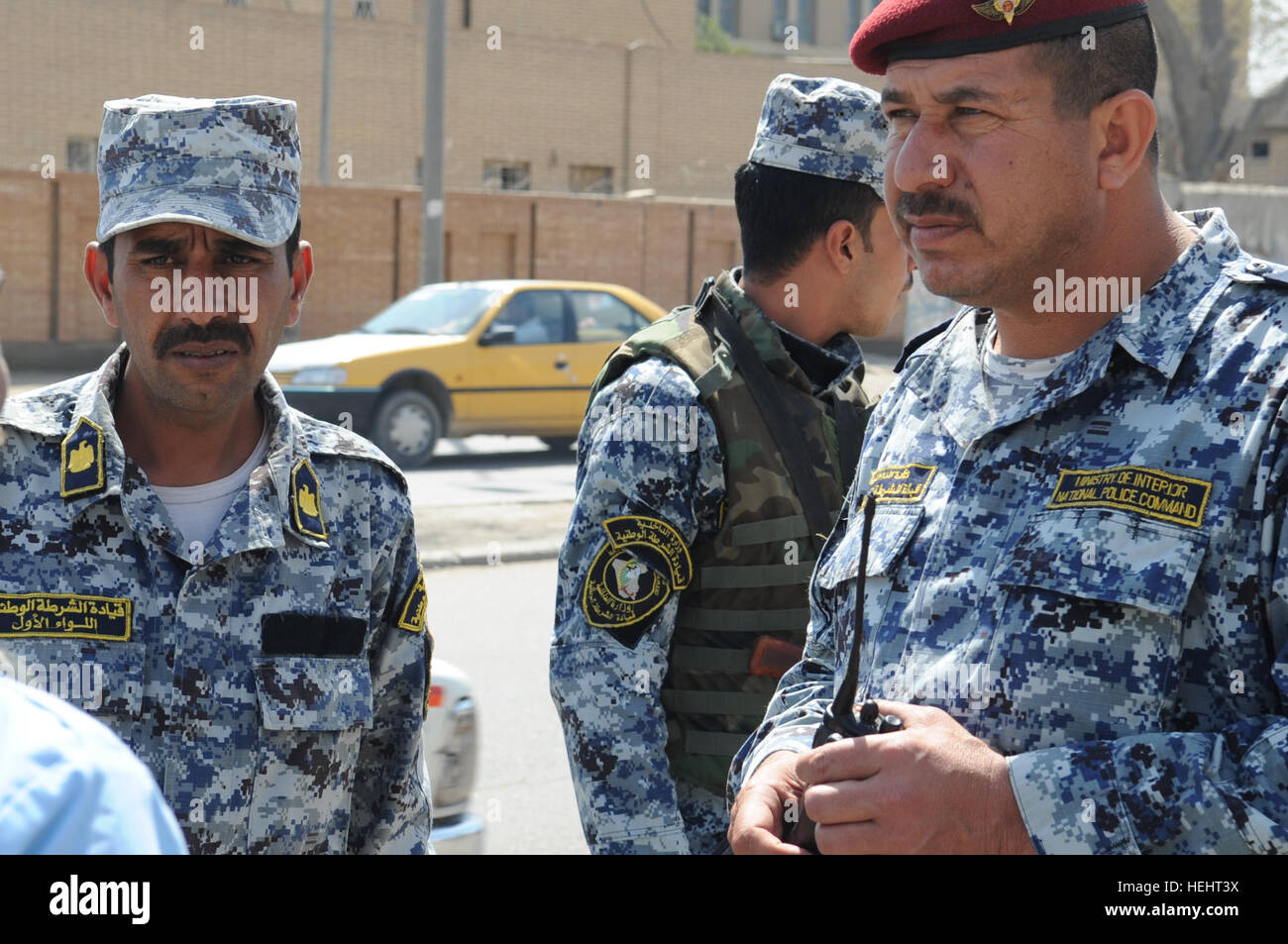 An Iraqi policeman meets with Lt. Col. Muhammed (right) of the Iraqi ...