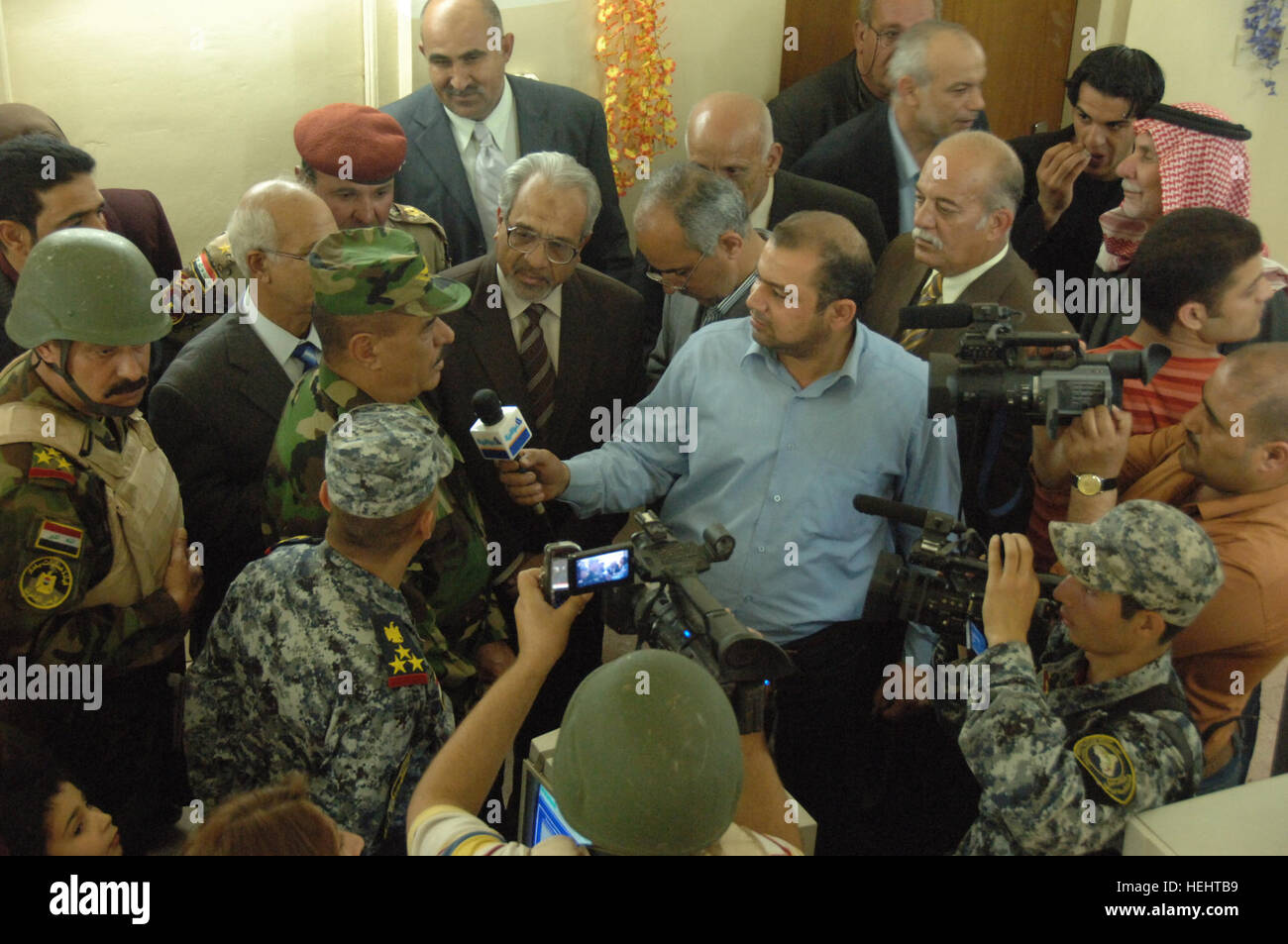 An Iraqi National Police representative speaks with members of the ...