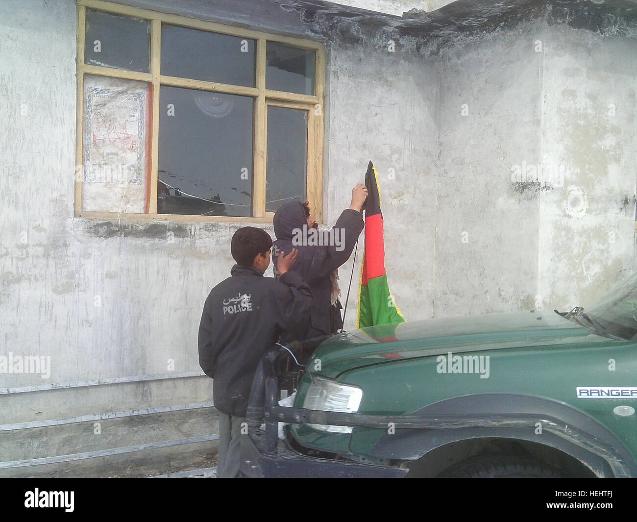 Members of the Afghanistan National Police 8, raise the Afghanistan ...