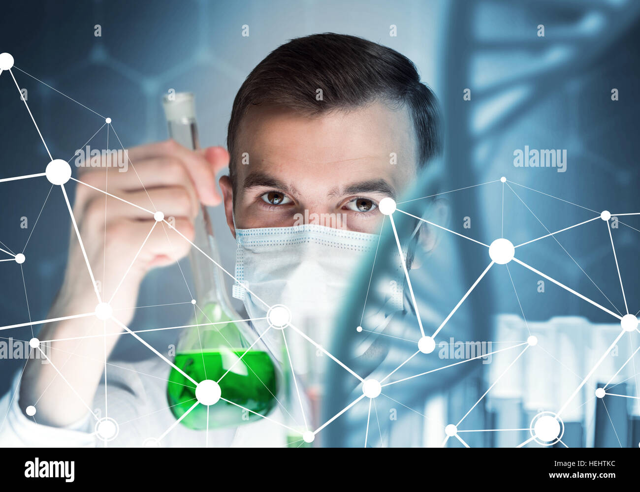 Young scientist mixing reagents in glass flask in clinical laboratory ...