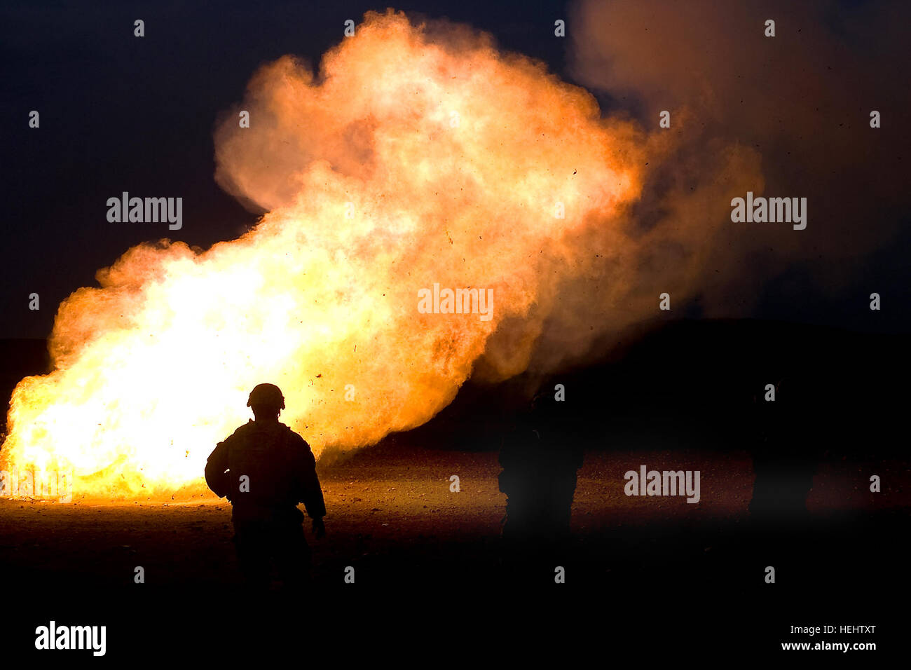 U.S. Army infantryman observes the disposal of unused mortar charges ...