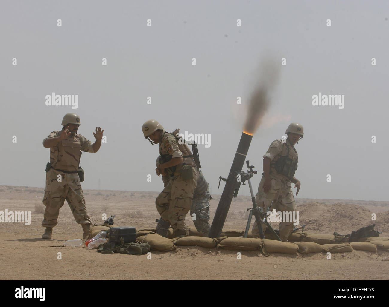 Soldiers from the 17th Iraqi Army Division fire 120 mm mortars during a ...