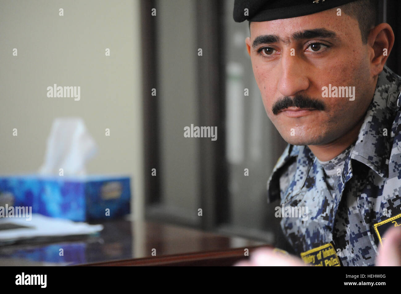 An Iraqi national police officer listens during a meeting with U.S ...