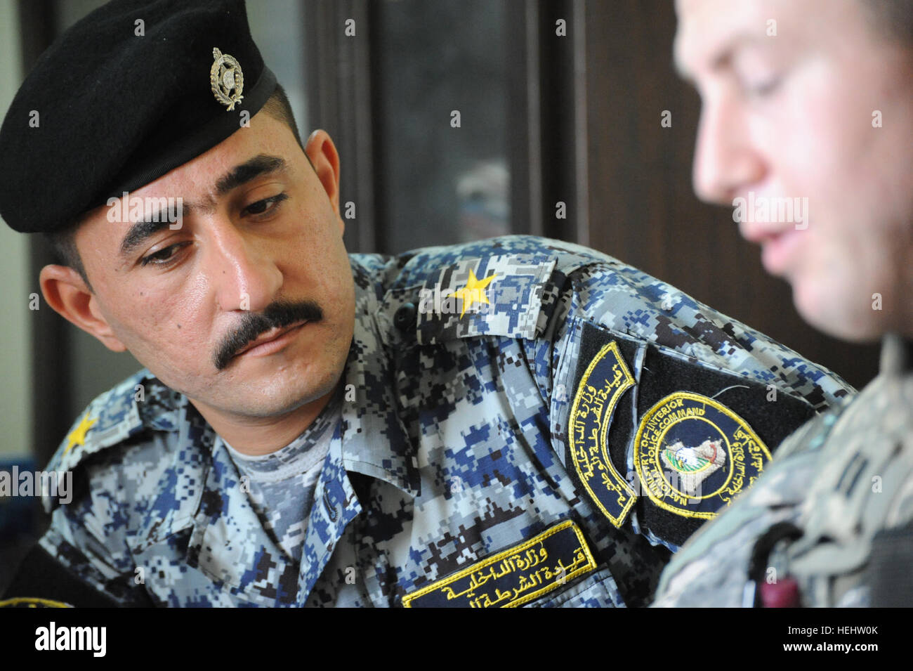 An Iraqi national police officer listens during a meeting with U.S ...