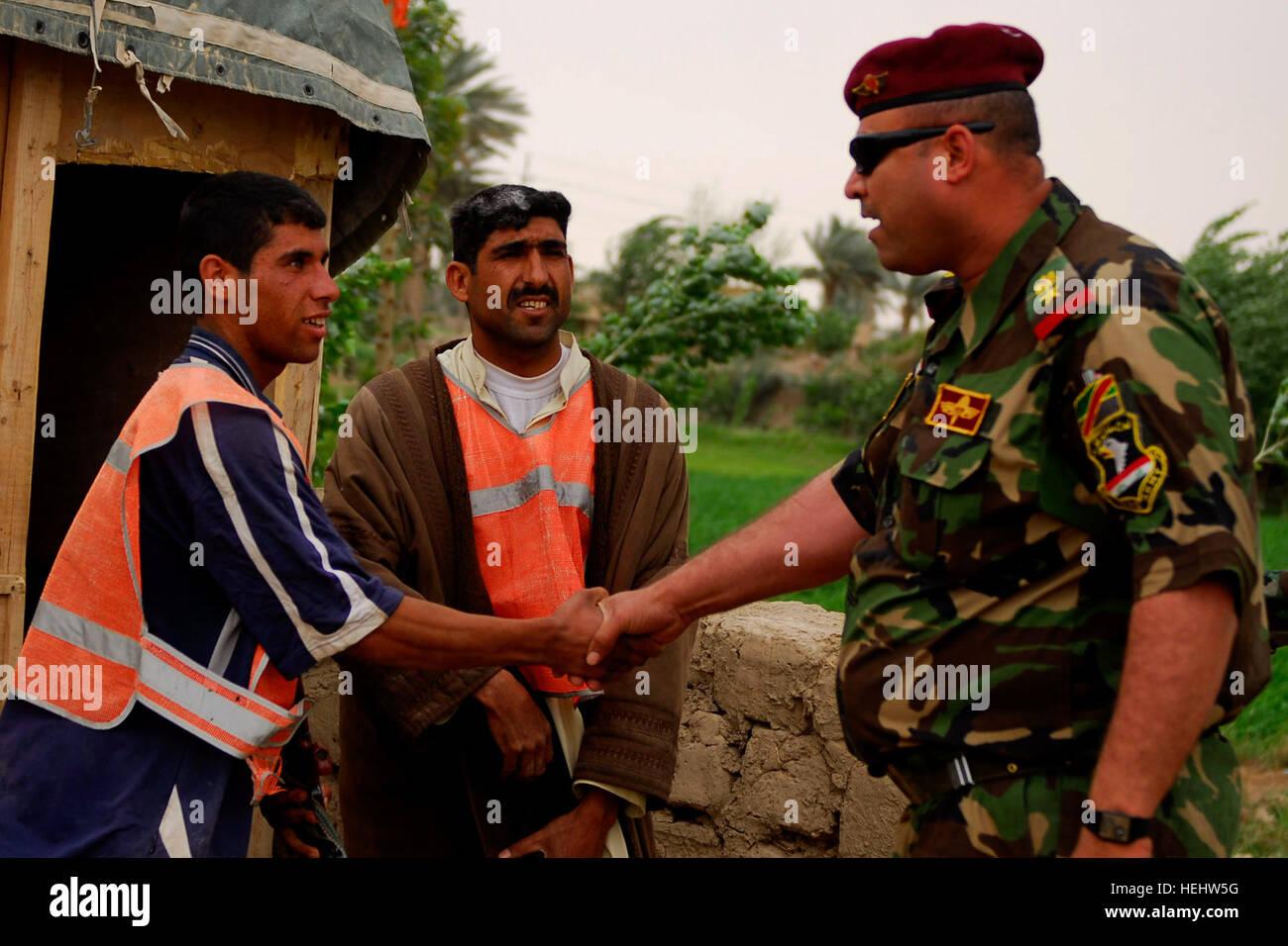 Local Sons of Iraq (left), greet Lt. Col. Ayoob, commander, Commando ...