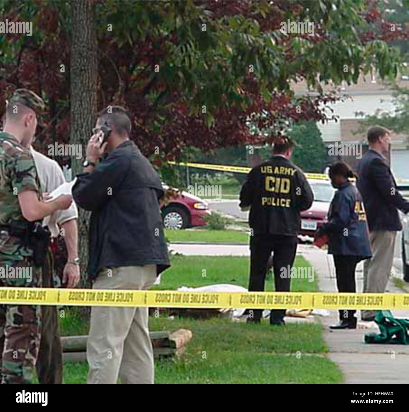 U.S. Army Criminal Investigation Division agents examine and document a ...