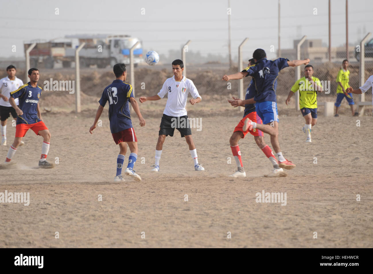 Iraqis play soccer using a newly donated soccer ball in the Al-Madain ...
